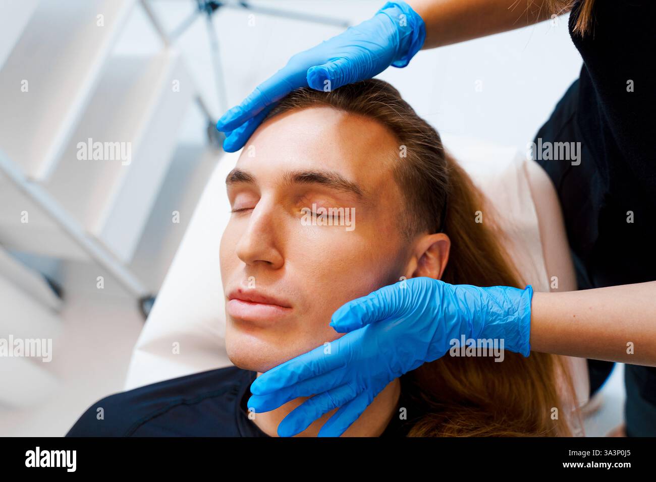 Male facial skincare procedure in beauty salon. Man is doing soothing ...