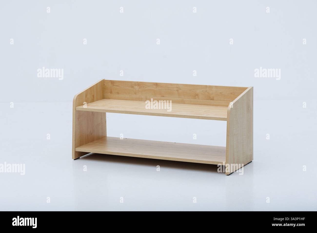 A sturdy wooden bench featuring two spacious shelves placed on a clean ...