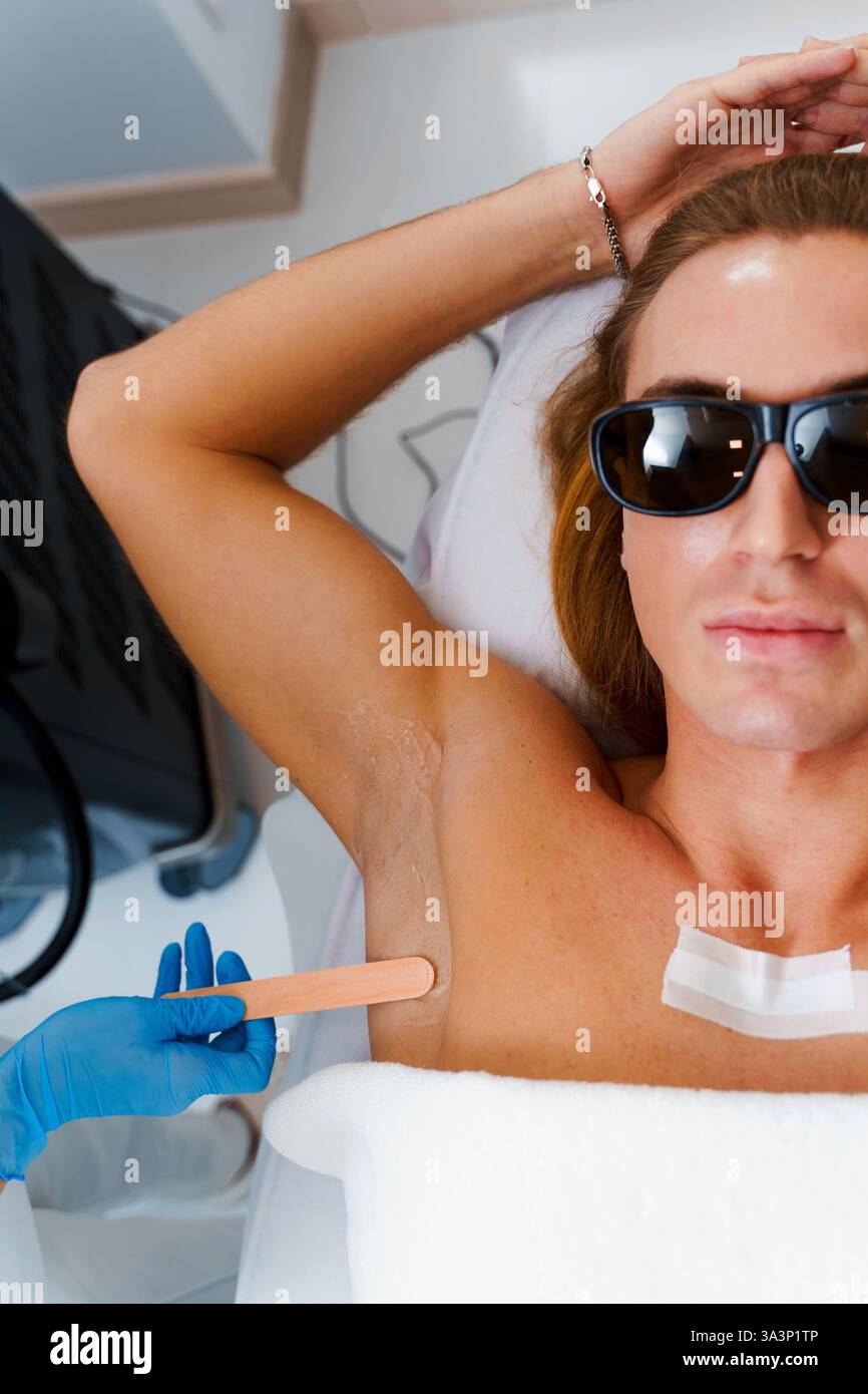 Applying hydrogel on man's armpits zone before laser epilation. Getting ...