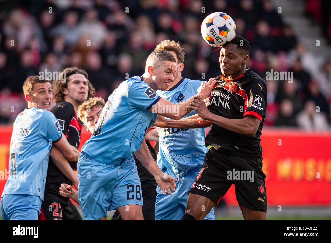 Herning, Denmark. 16th Mar, 2025. Ousmane Diao (4) of FC Midtjylland and Andre Romer (28) of ...