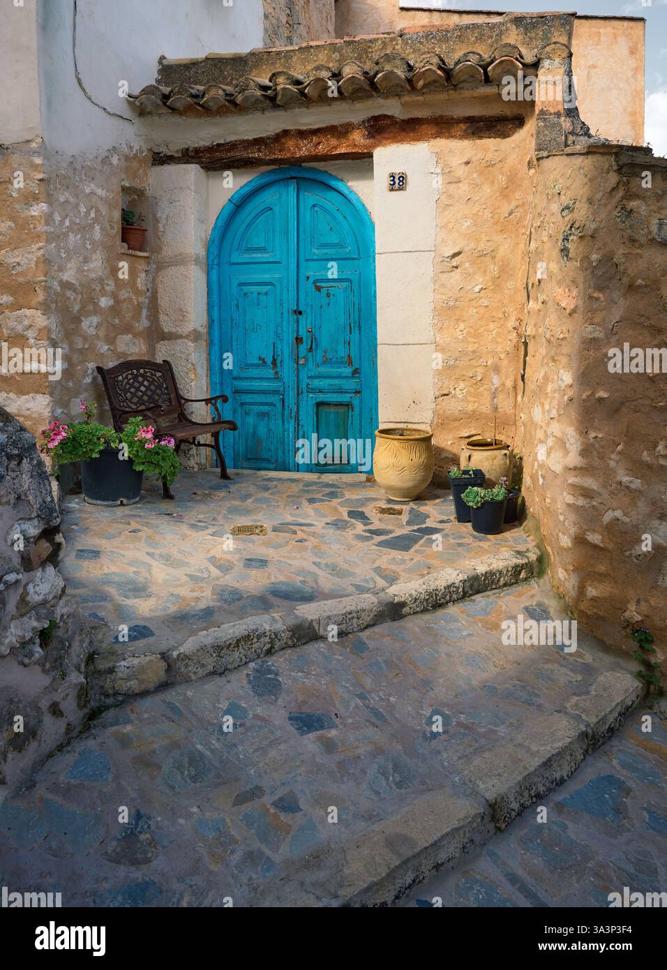 Cozy old street corner with a bright blue door Stock Photo - Alamy