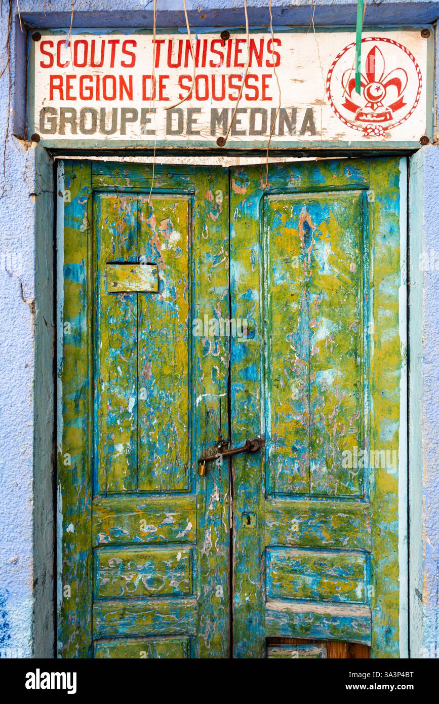 A very old weathered weather beaten door of the scout hall in Sousse ...