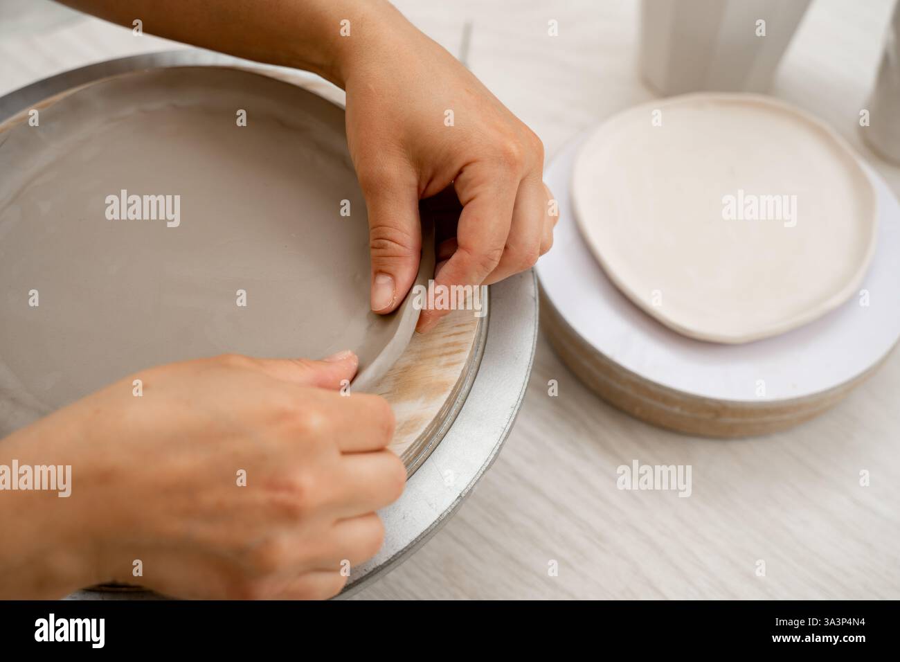 Creating ceramic products from flat sheets of clay. Using hands to ...