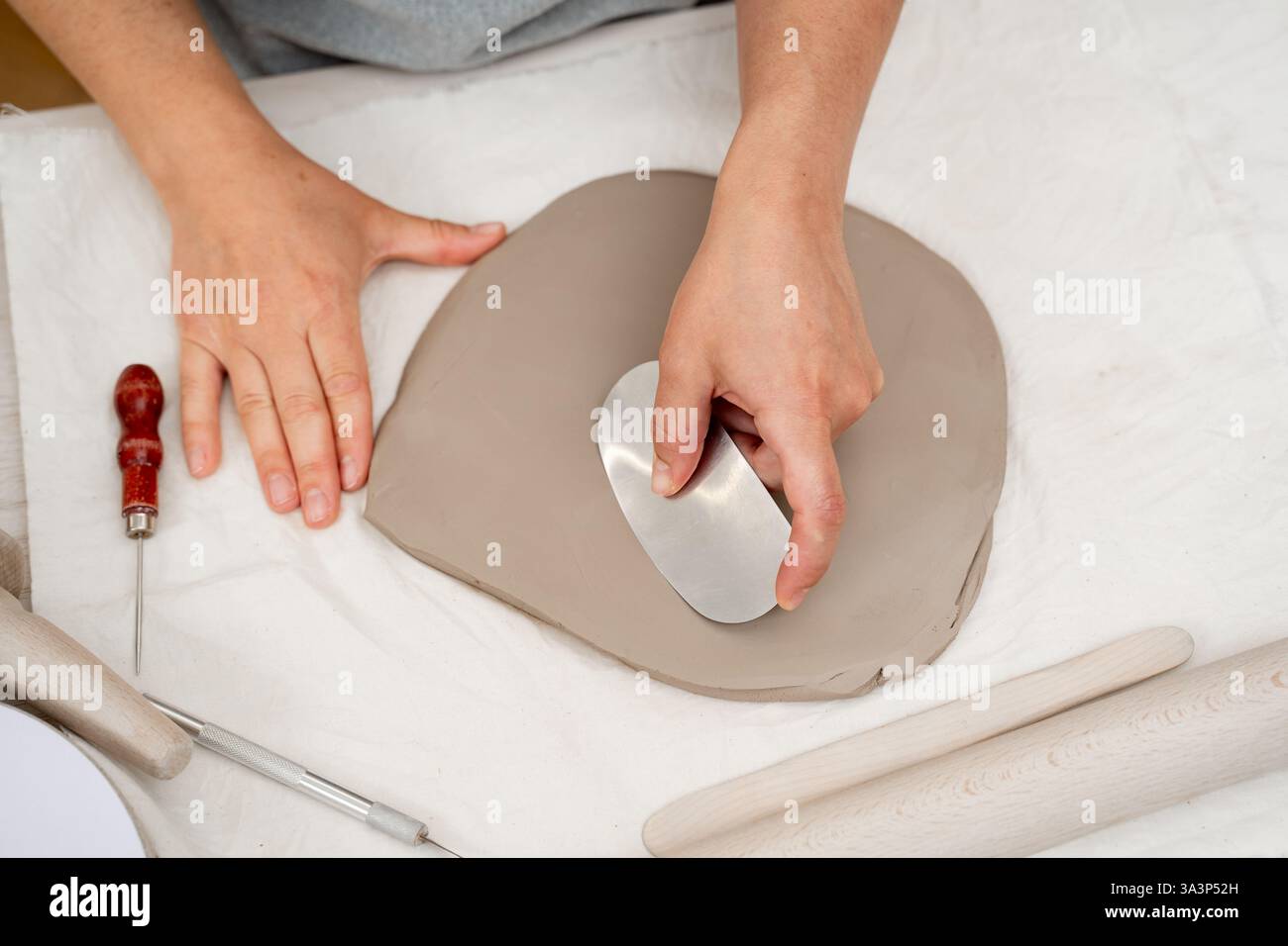 Creating perfect homogenous consistence for ceramics handcraft. Wedging ...