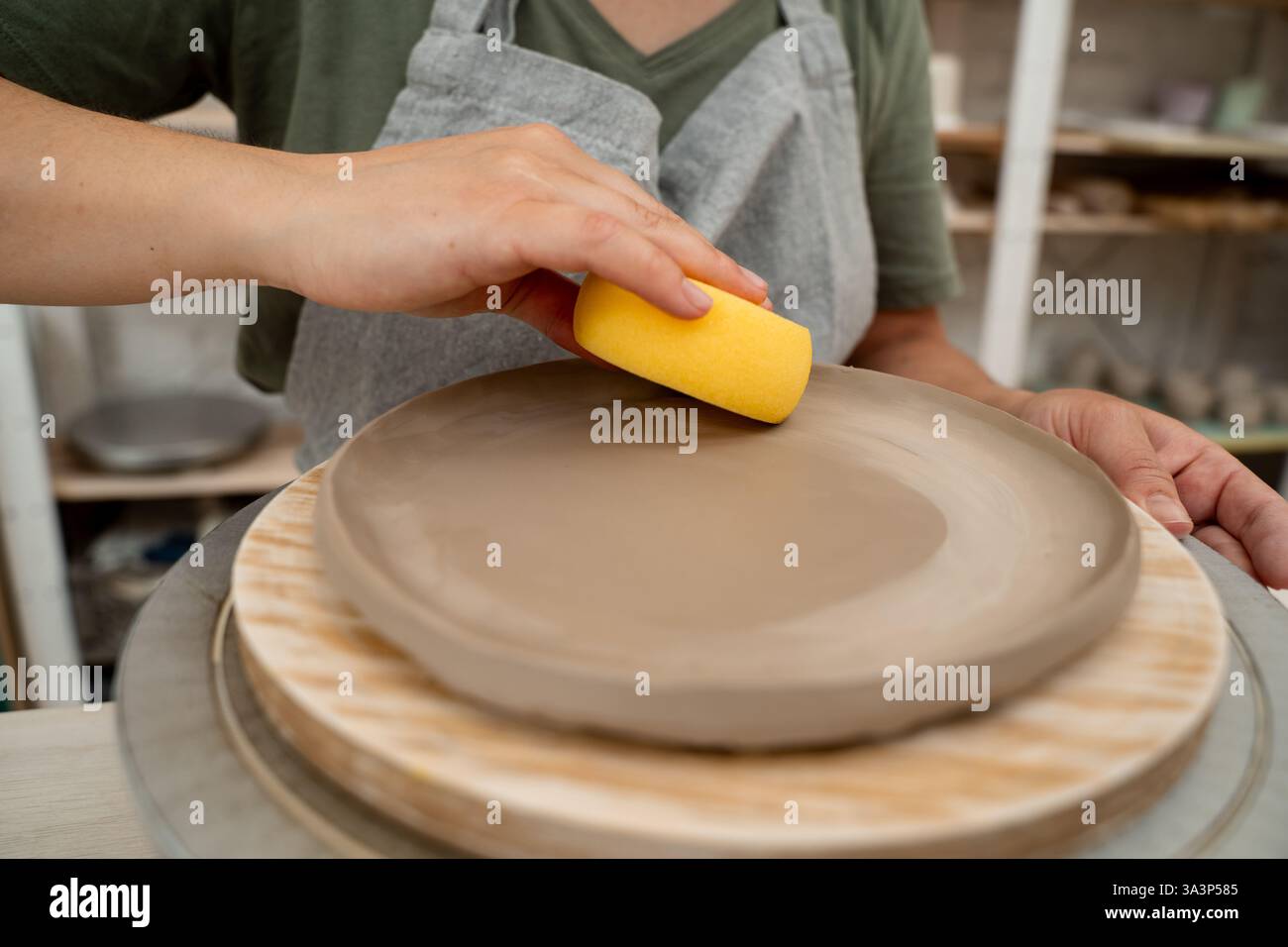 Using sponge for pottery class. Absorbing sponge to get rid of excess ...