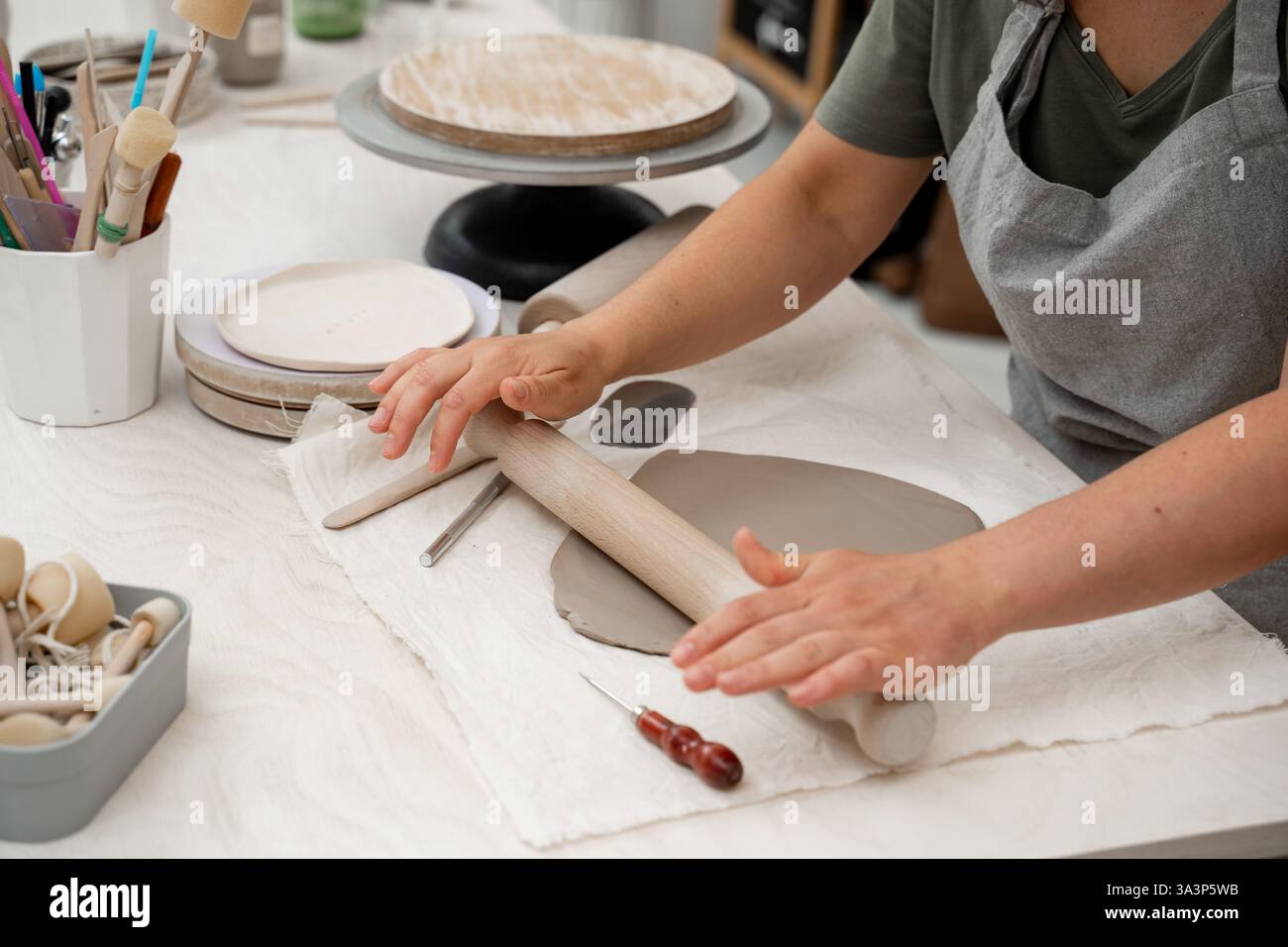 Preparing clay for cutting and assembling it. Slab building method in ...