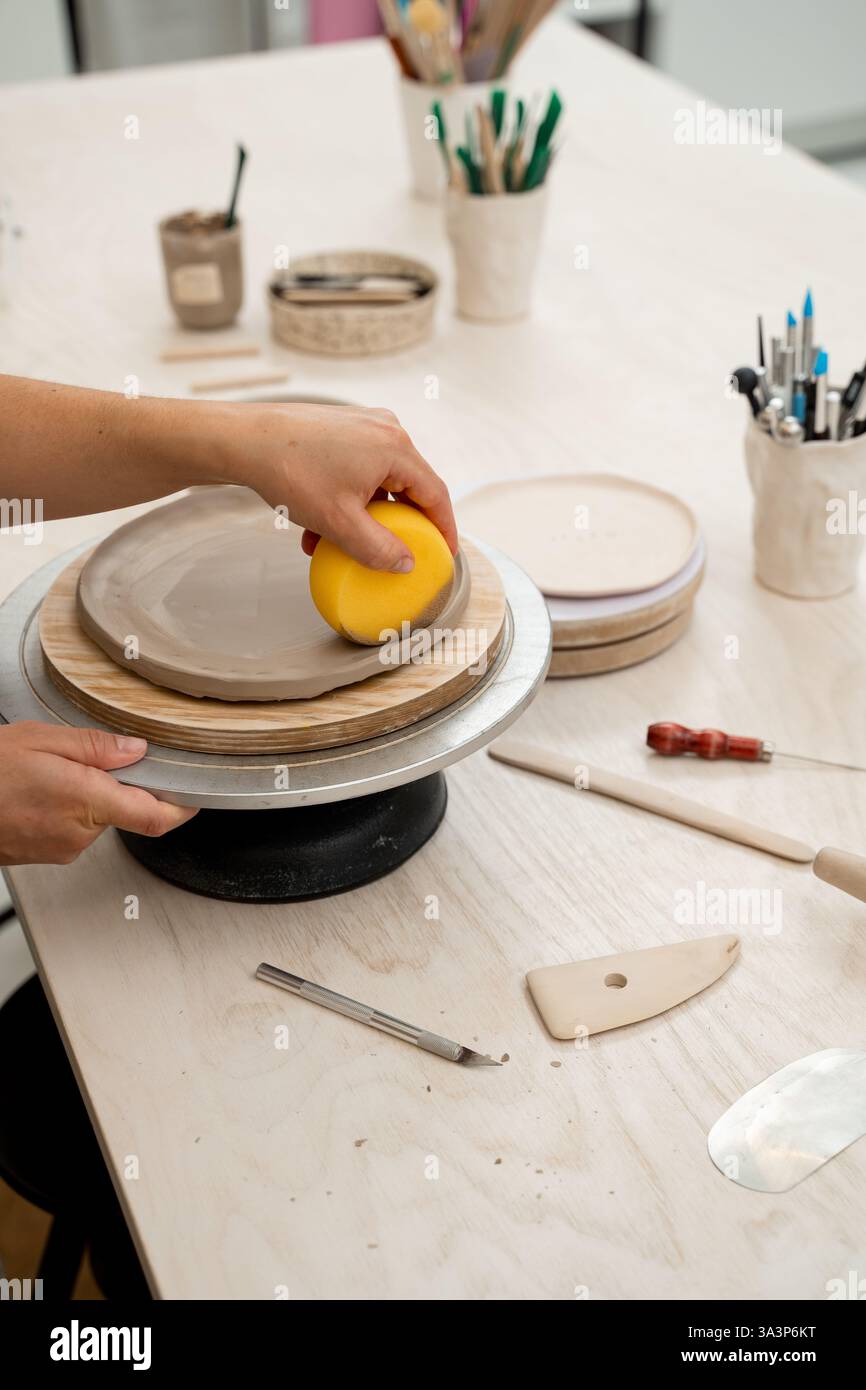 Using sponge for pottery class. Absorbing sponge to get rid of excess ...