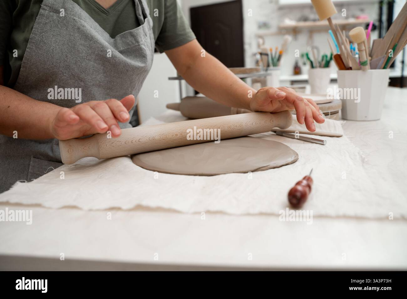 Preparing clay for cutting and assembling it. Slab building method in ...