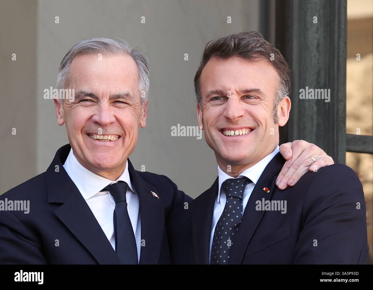 French President Emmanuel Macron (L) greets new Canadian Prime Minister ...