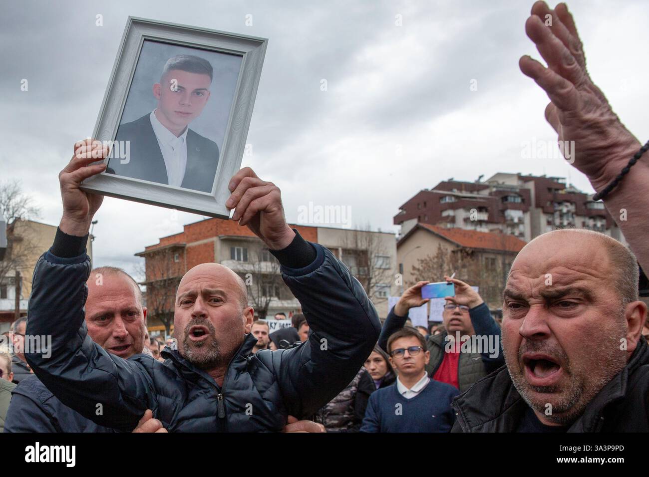 Dragi Stojanov, left, holds a photograph of his son Tomche Stojanov ...