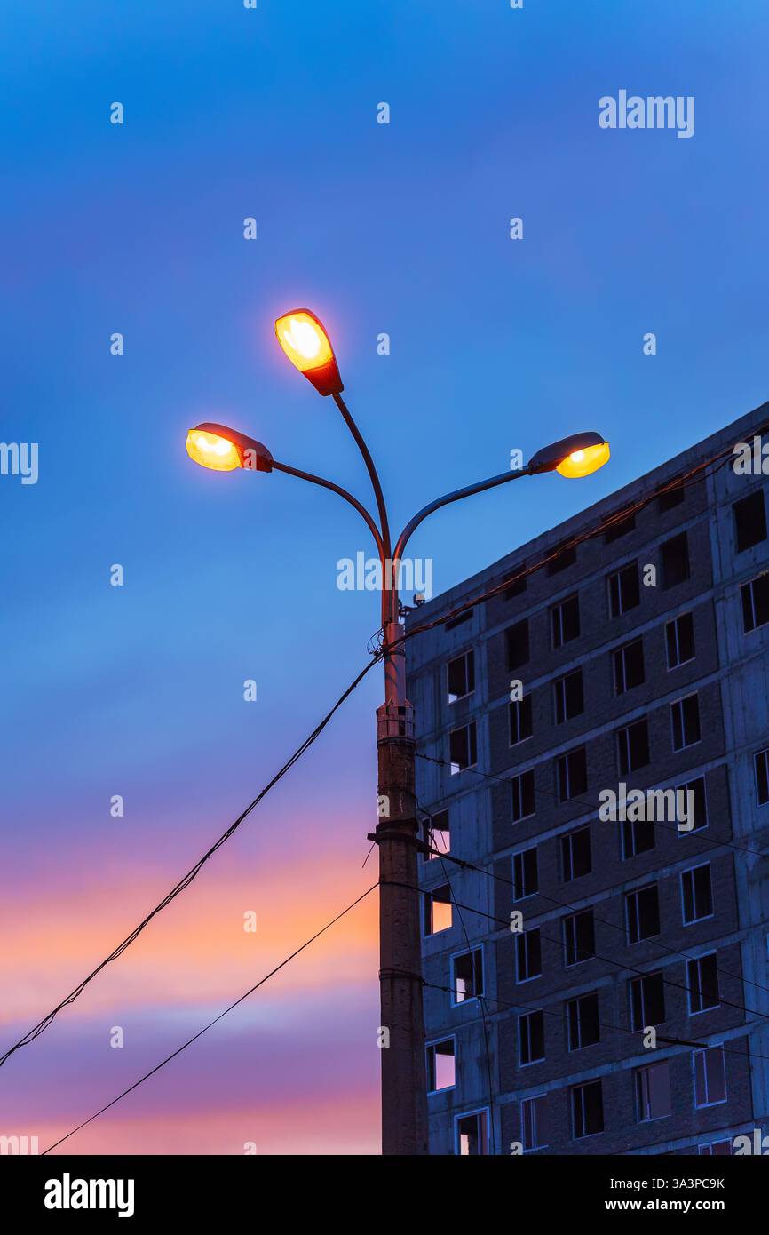 unfinished high-rise building against the backdrop of the sunset sky ...
