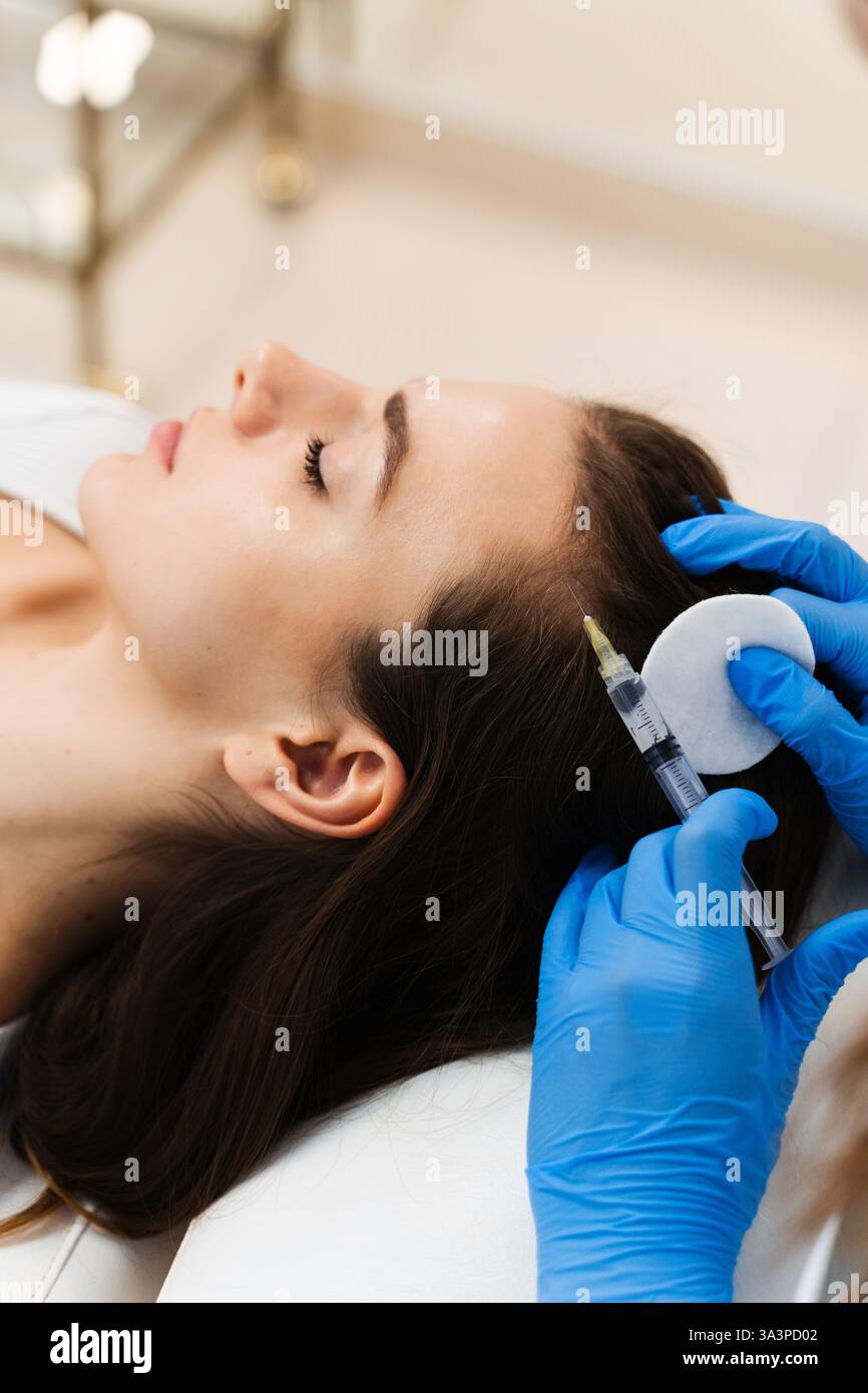 Injection hair follicles with special cosmetology syringe. Mesotherapy ...