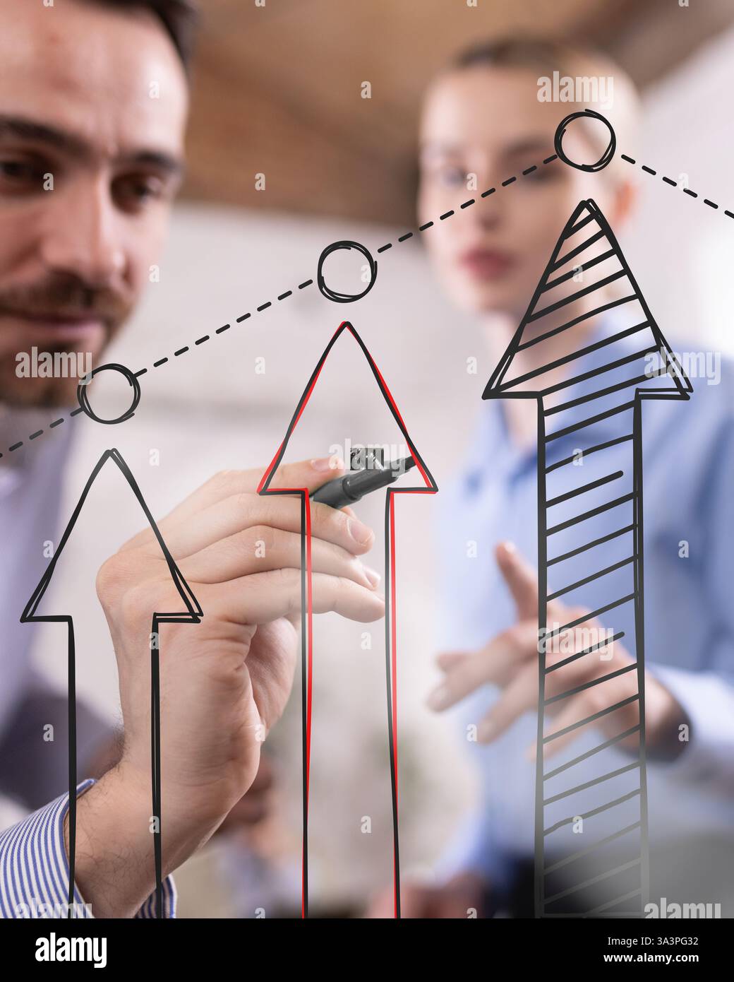Focused businessman illustrating business growth strategy, drawing ...
