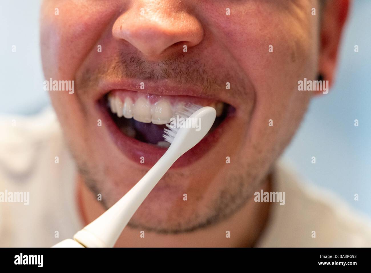 Bavaria, Germany - March 16, 2025: A man brushes his teeth with ...