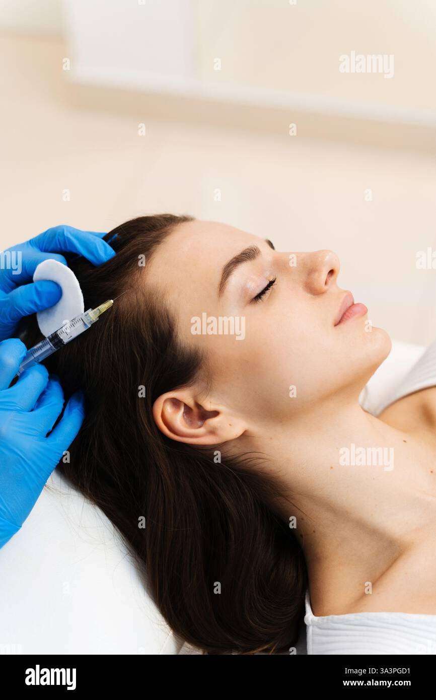 Injection hair follicles with special cosmetology syringe. Mesotherapy ...