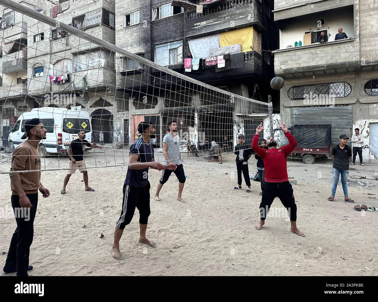 Palestinians play volleyball amid the rubble of destroyed buildings in ...