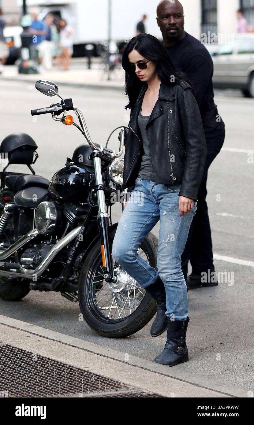 Krysten Ritter and Mike Colter shoot a scene on a motorcycle on the set ...