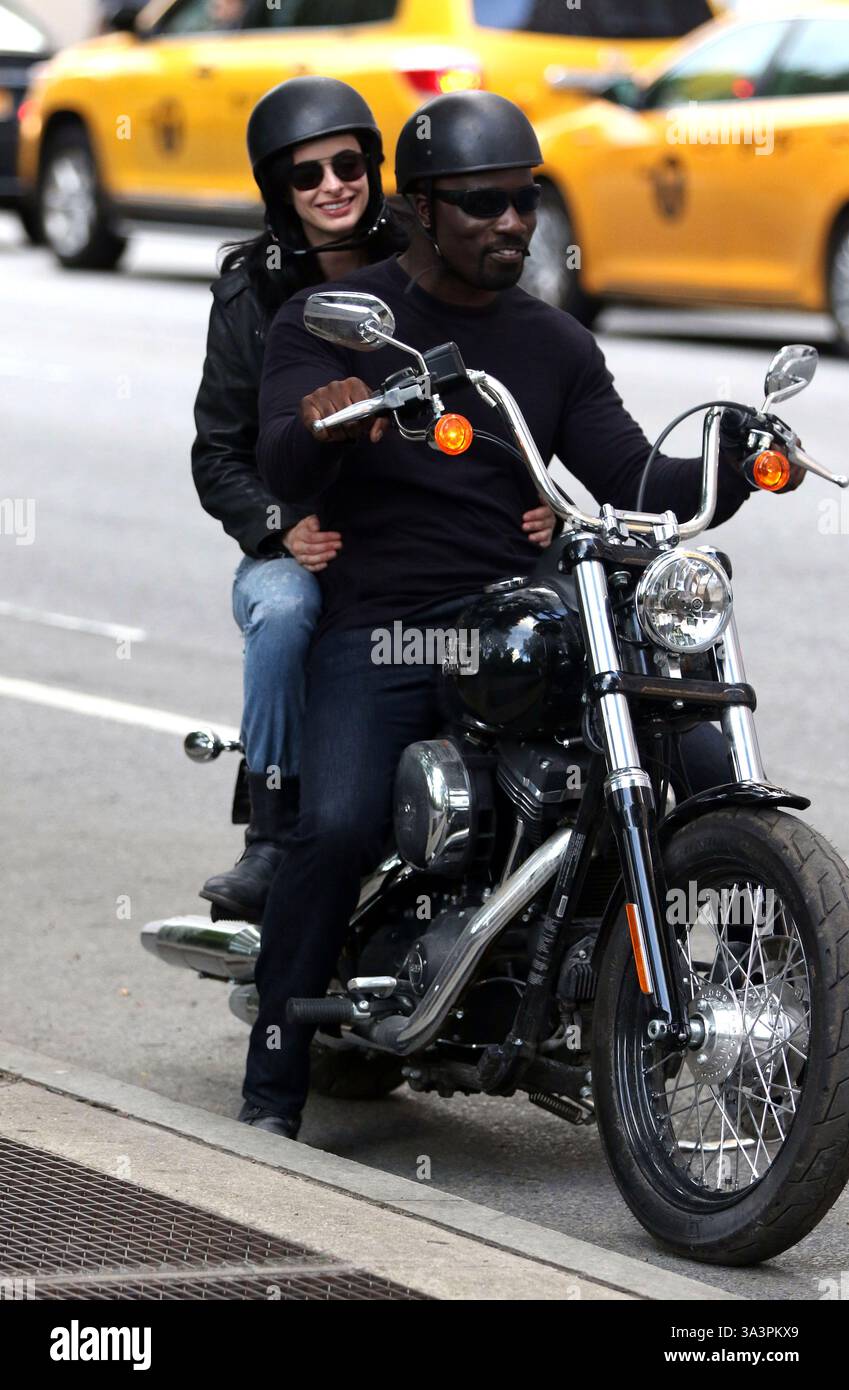 Krysten Ritter and Mike Colter shoot a scene on a motorcycle on the set ...