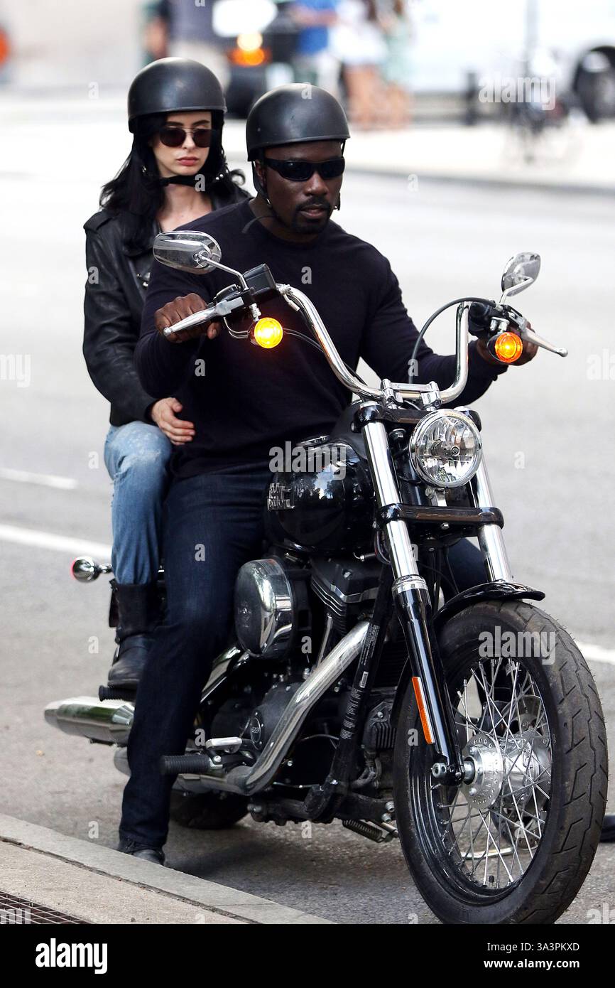 Krysten Ritter and Mike Colter shoot a scene on a motorcycle on the set ...