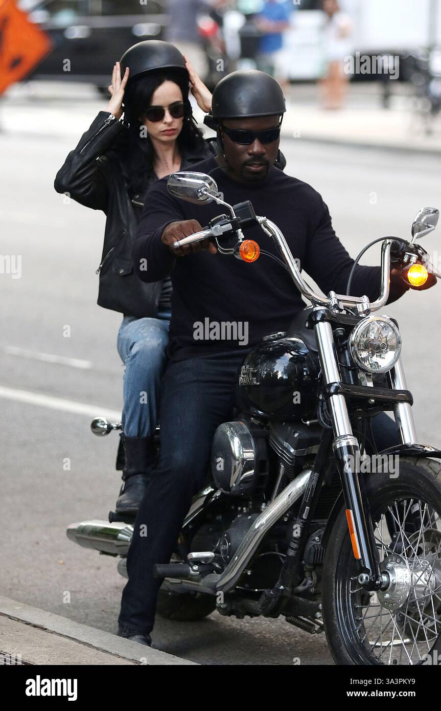 Krysten Ritter and Mike Colter shoot a scene on a motorcycle on the set ...