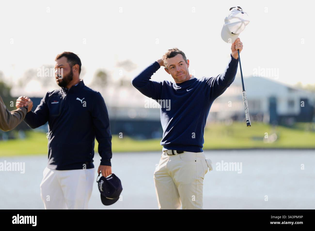 Rory McIlroy, right, of Northern Ireland, reacts after winning a ...