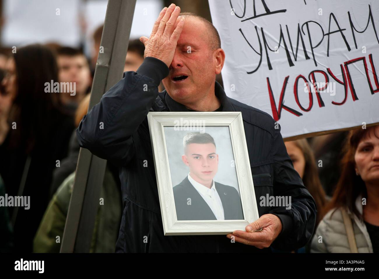A man holds a photograph of one of the victims of a massive nightclub ...