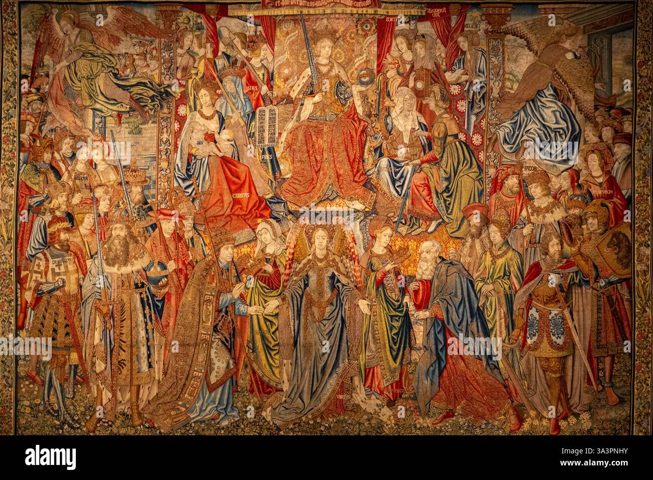 A large, intricate tapestry featuring a diverse group of people on it ...