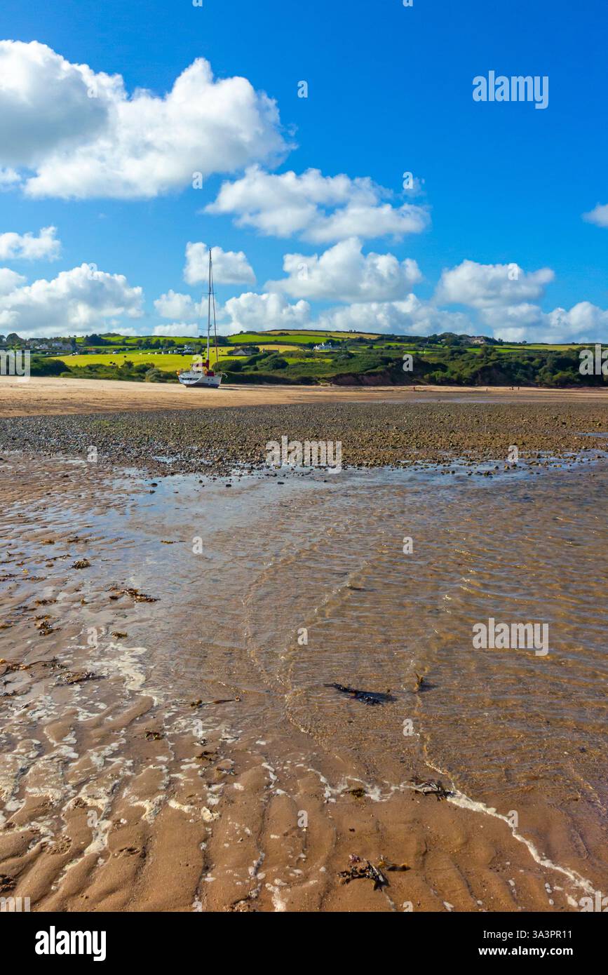 The sandy beach at low tide at Traeth Lligwy near Moelfre on the north ...