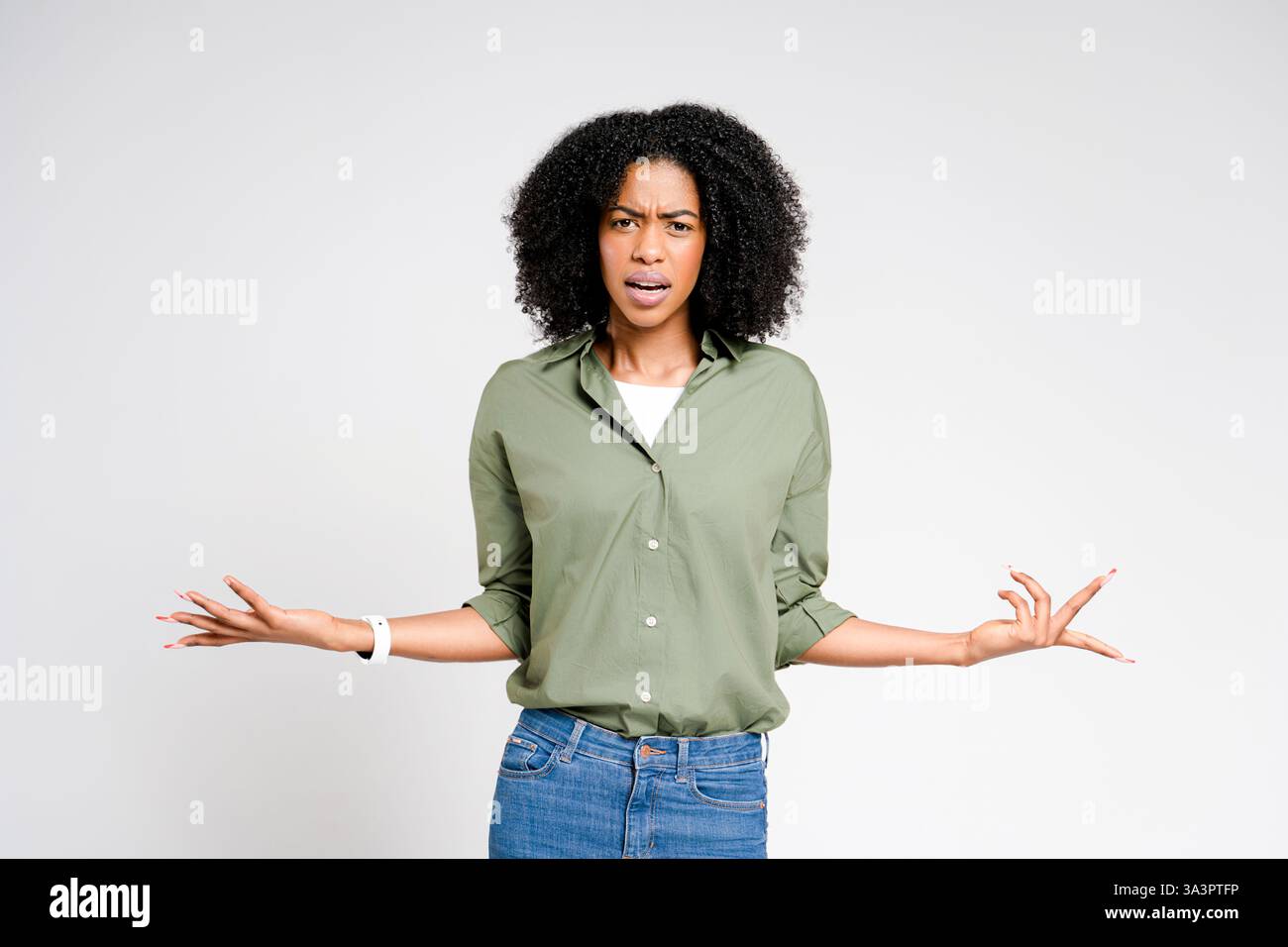 An African-American woman stands with an incredulous expression, her ...
