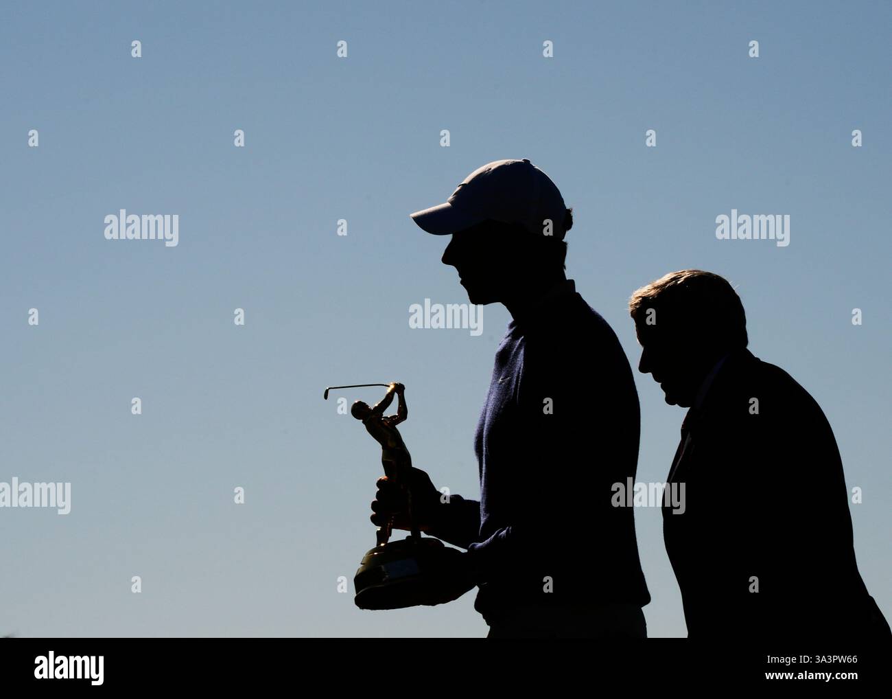 Rory McIlroy, left, of Northern Ireland, leaves a trophy ceremony after ...