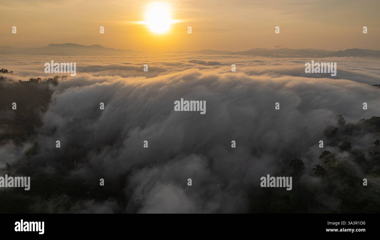 Breathtaking aerial view of the sun rising over a mountain valley ...
