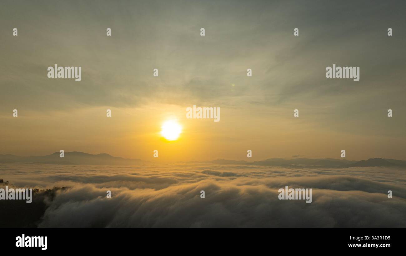 Breathtaking aerial view of the sun rising over a mountain valley ...