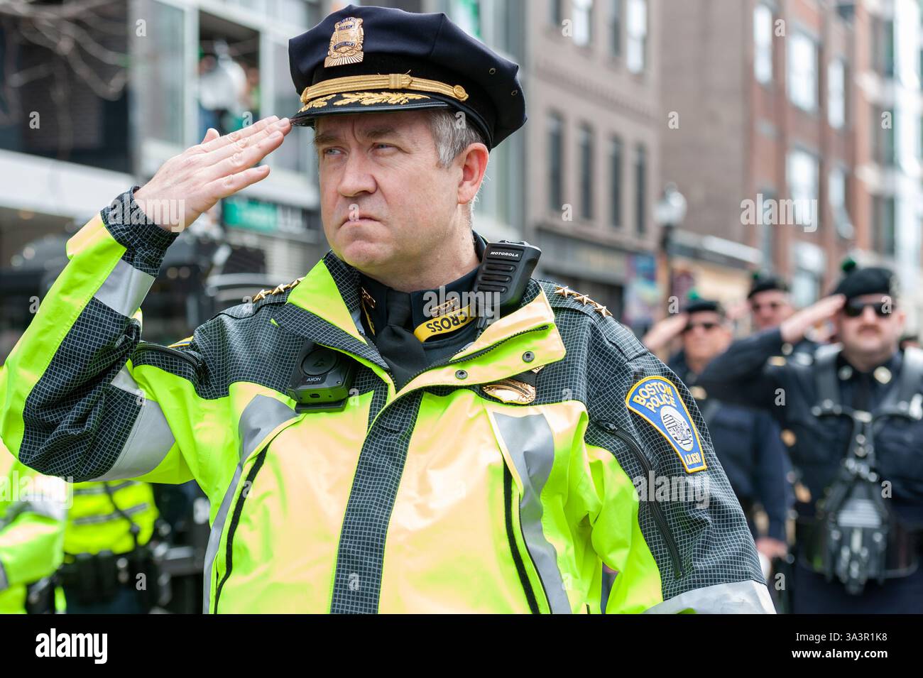 Boston Police officer saluting to the national anthem at the annual ...