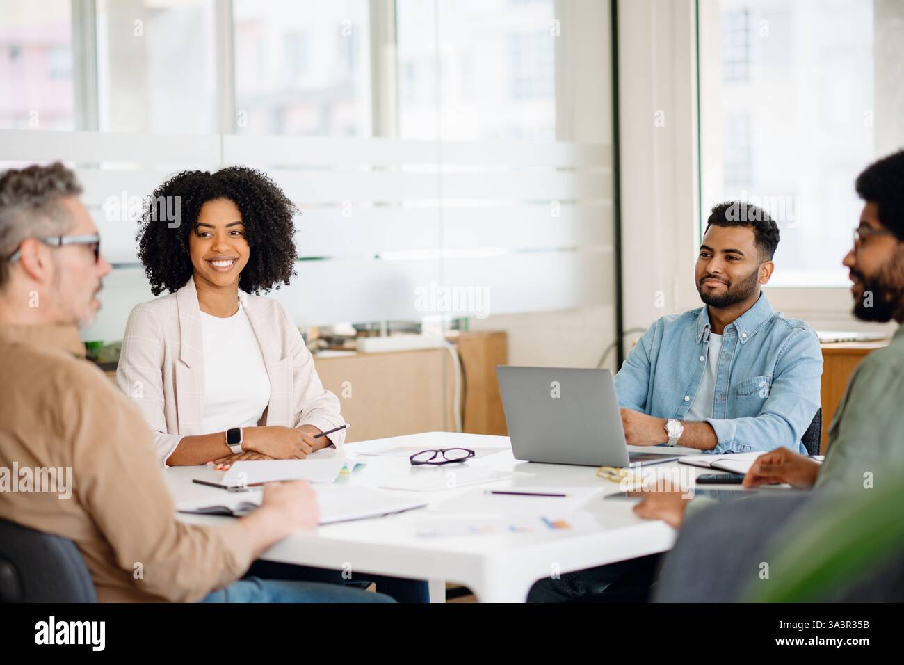 A diverse business team in a collaborative meeting, discussing new ...
