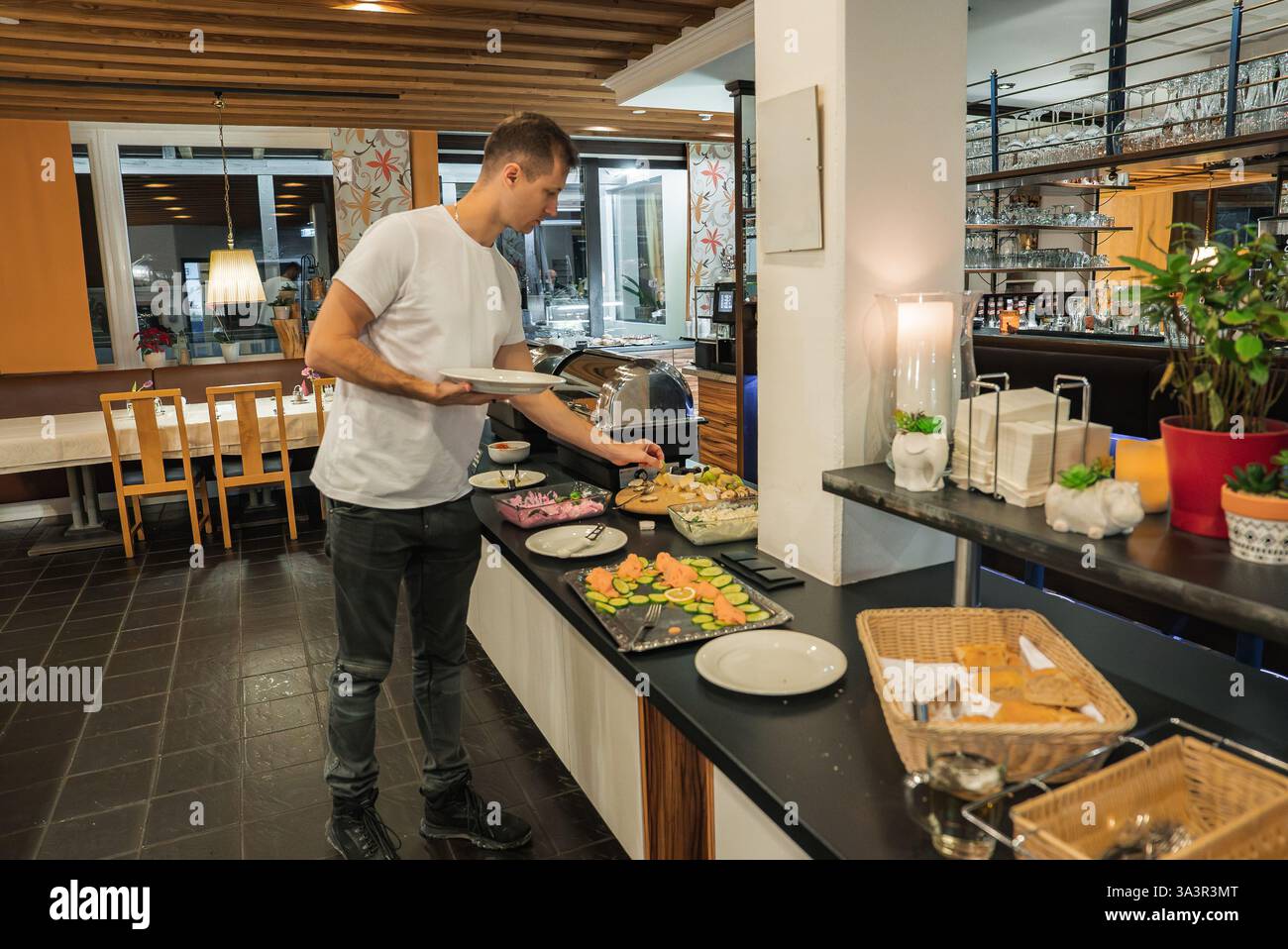Man Serving Food at Buffet in Modern Mountain Hotel Dining Area Stock ...