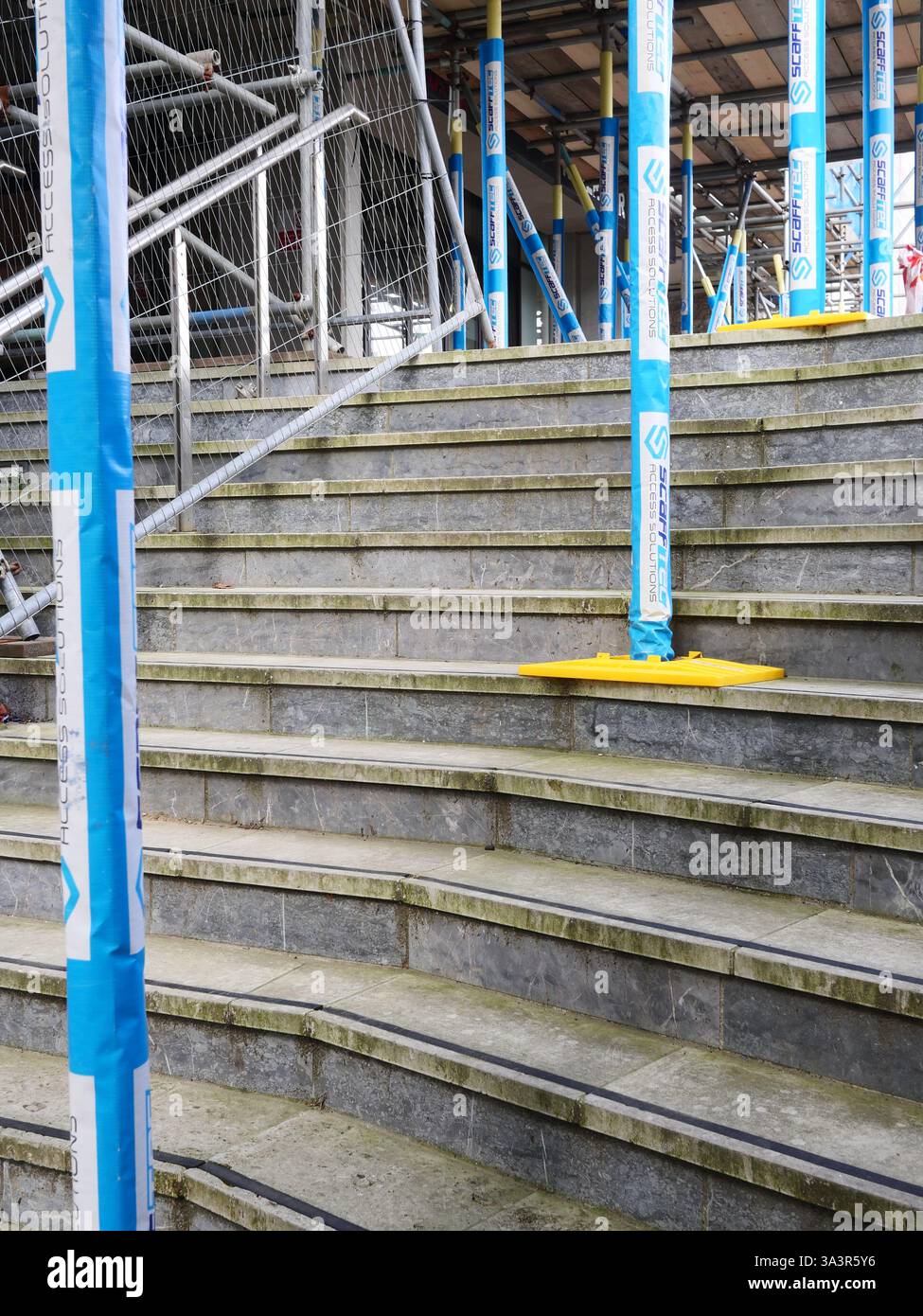 Scaffolding tower over steps with padded sleeving over scaffold poles ...