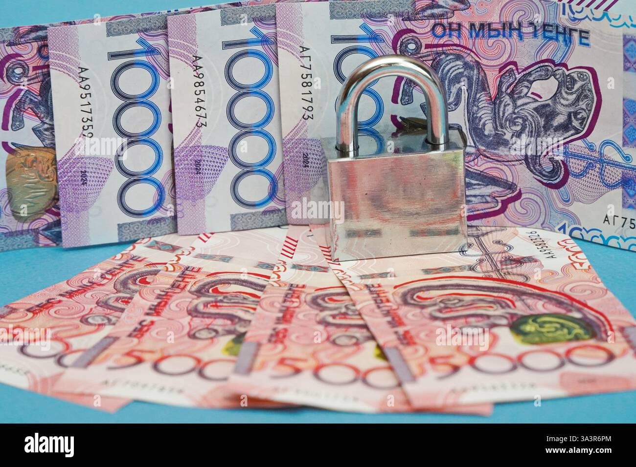 Metal lock and banknotes of Kazakhstani tenge 5000 and 10,000 Stock ...