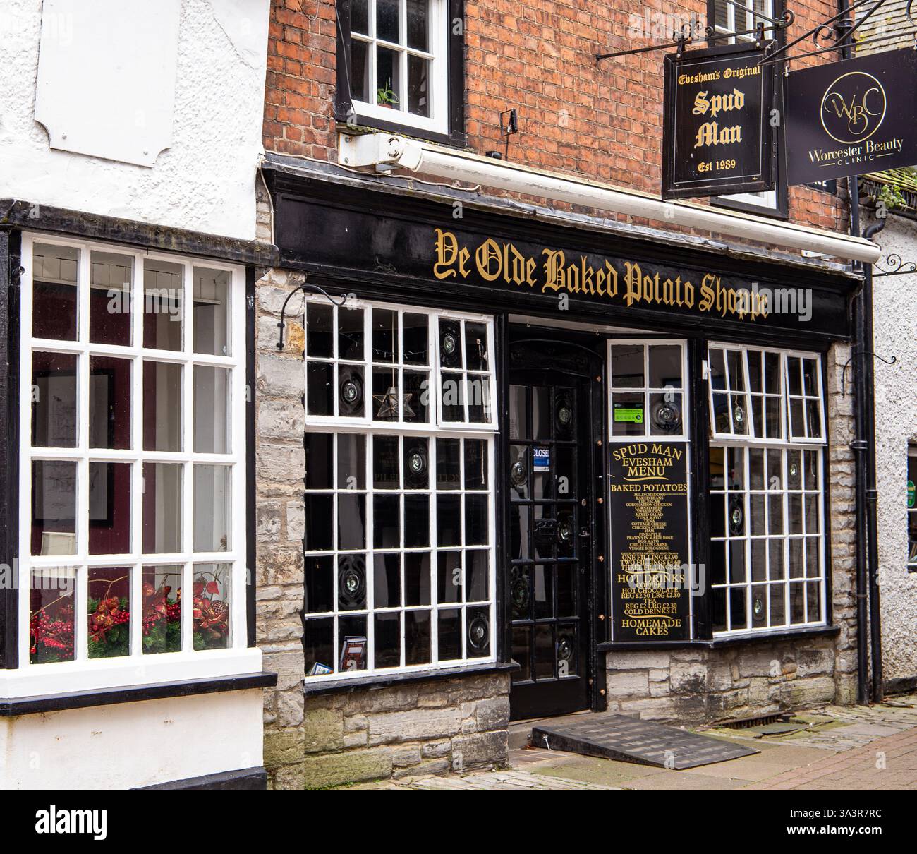 Front view of a charming vintage baked potato shop with a traditional ...