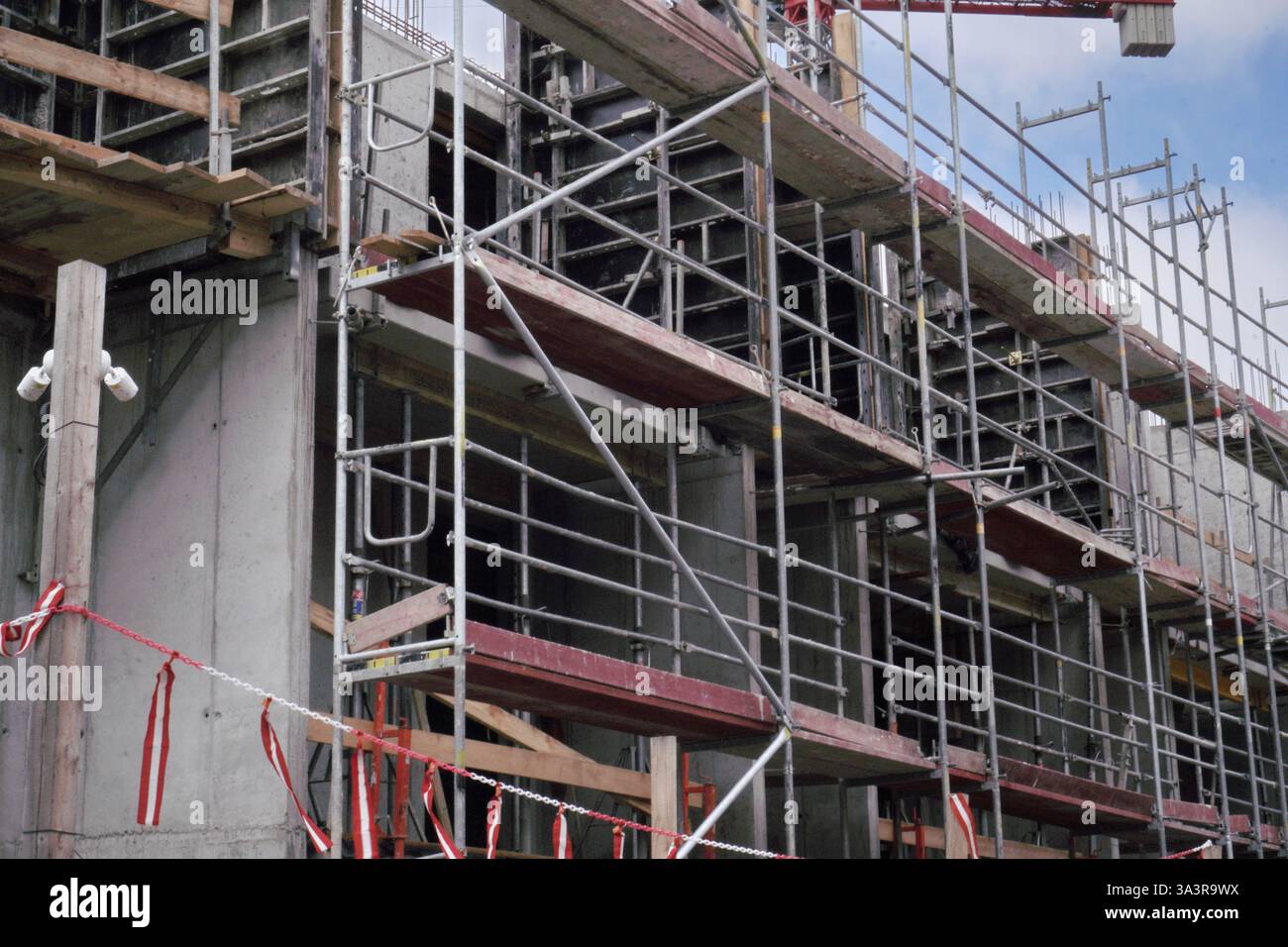 Scaffolding around new building. development new blocks. Scaffolding elected for residential ...