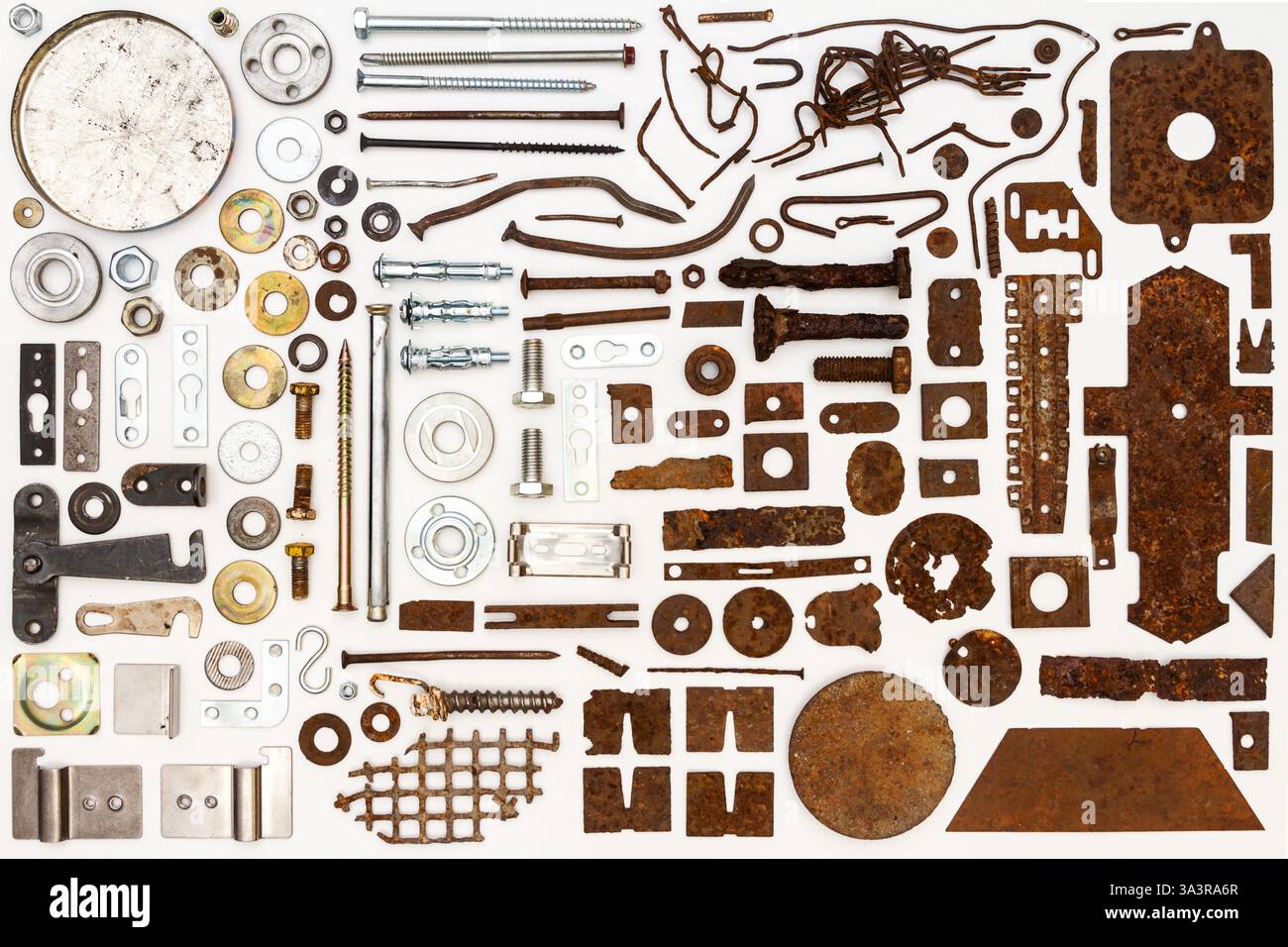 A group of various old and new parts arranged on white. Old rusty nuts ...