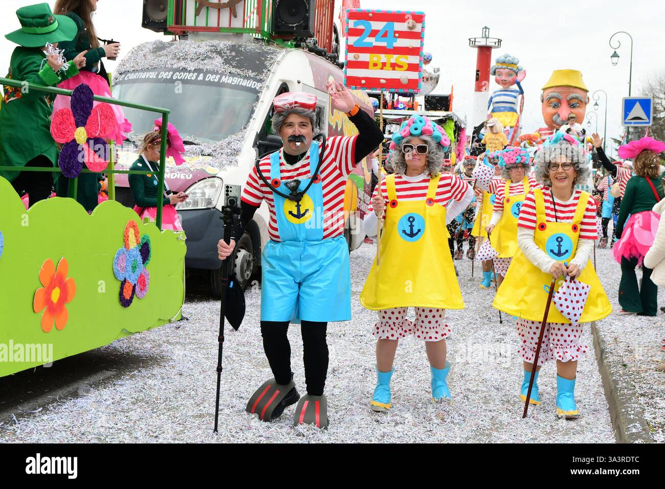 A man with a diving mask and women with foam rollers take part during ...