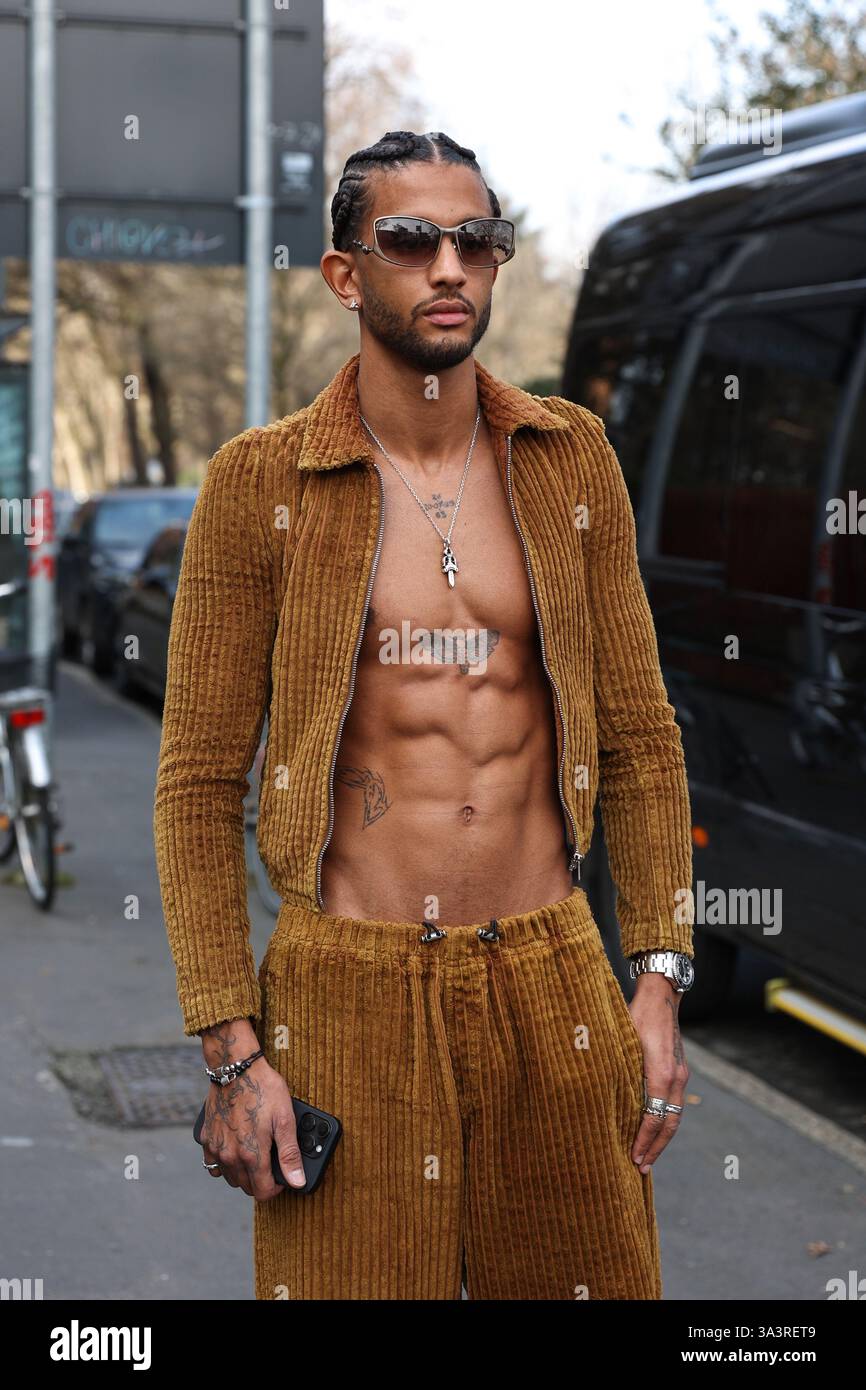 Milan, Italy. 26th Feb, 2025. A guest poses for photos before FW 2025/ ...