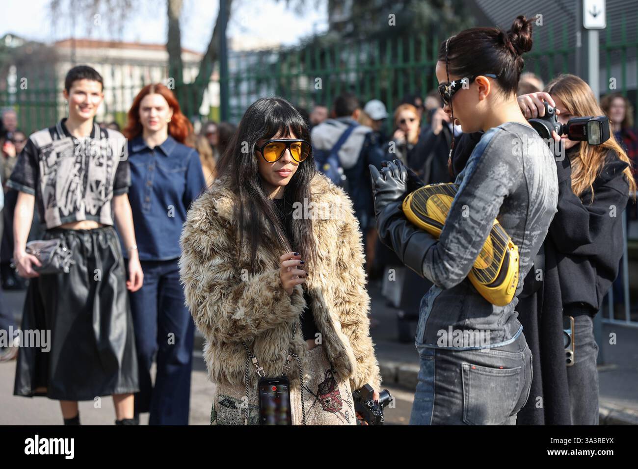 Milan, Italy. 26th Feb, 2025. A guest poses for photos before FW 2025/ ...