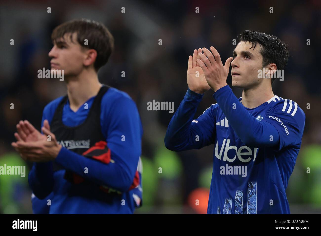 Milan, Italy, 15th March 2025. Nico Paz and Anastasios Douvikas of Como ...