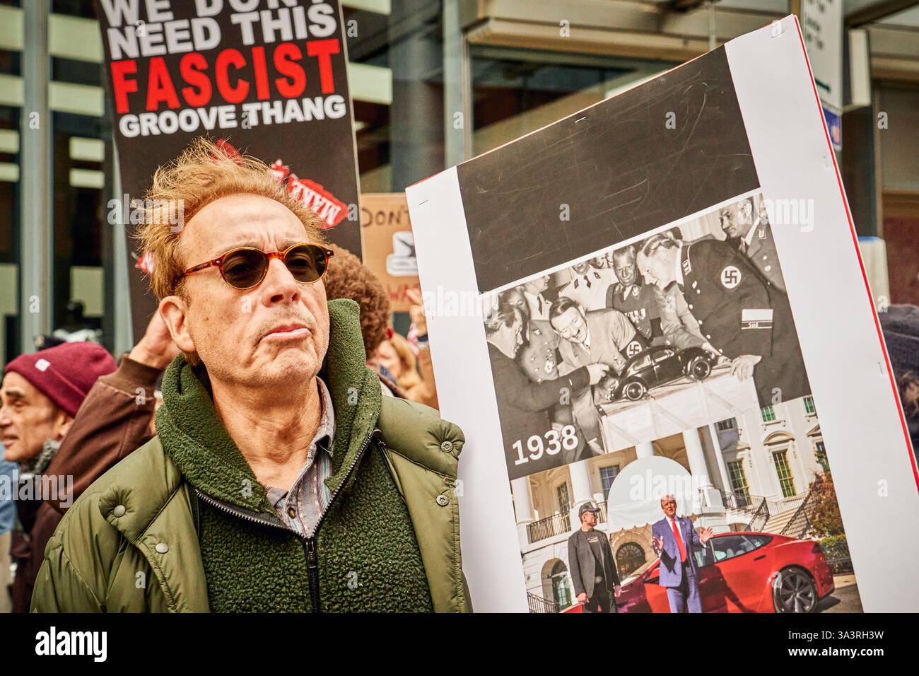New York, Ny, USA. 15th Mar, 2025. Protestor holds sign comparing ...