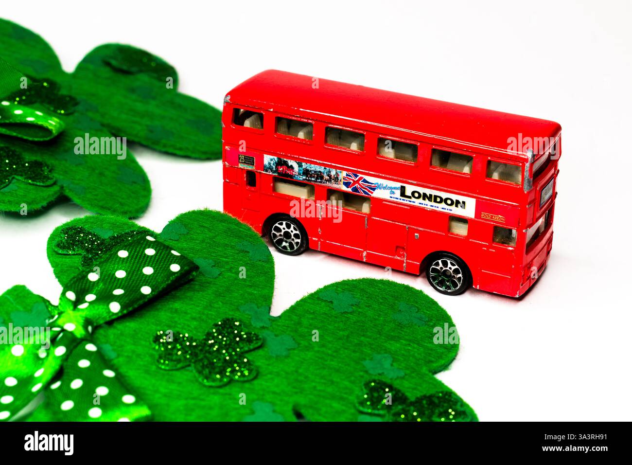 Red London bus with shamrocks isolated on white background with copy ...