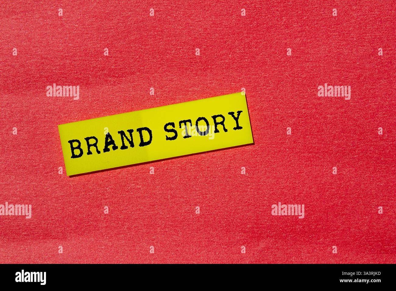 Brand story message written on yellow paper label on red background ...