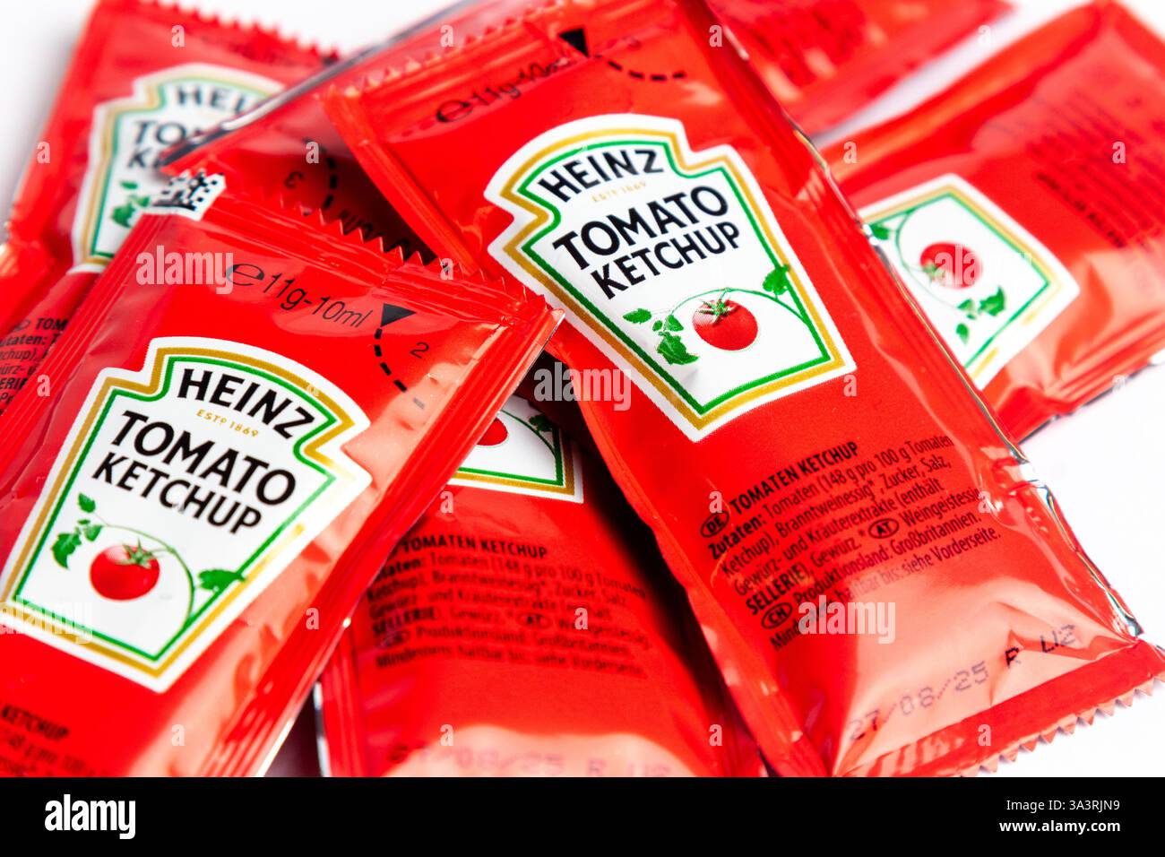 London, United Kingdom 10th March 2025 :- Sachets of Heinz Tomato Ketchup. Studio Shot Against A ...