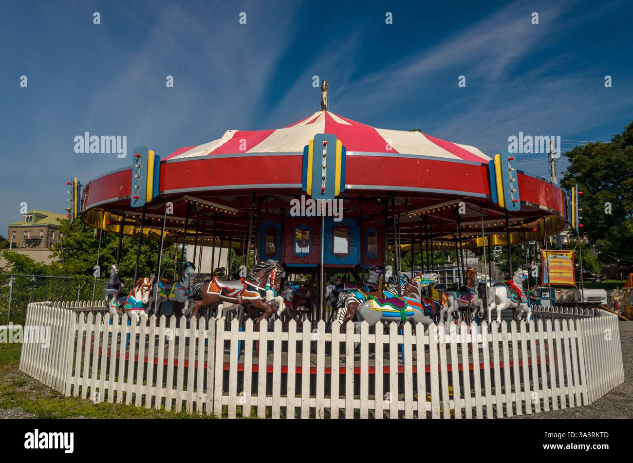 Empty Vintage Carousel Horse Ride enclosed by a white picket fence ...