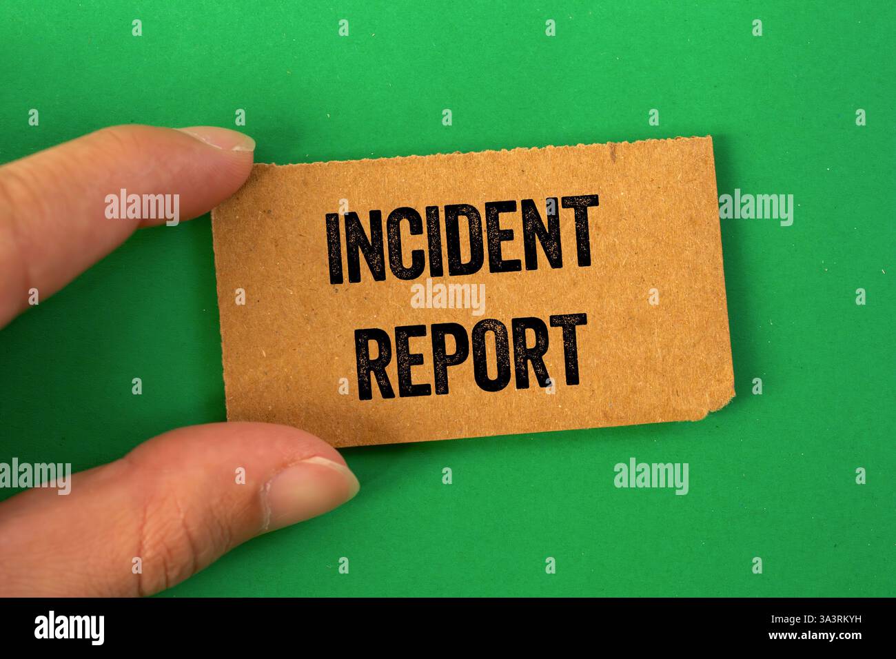 Incident report message written on cardboard paper on green background ...